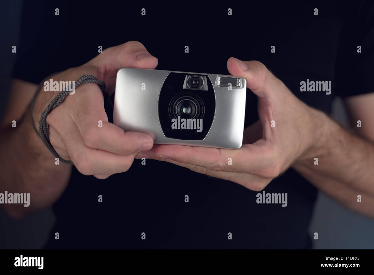 Man taking snapshot picture with vintage plastic generic film camera ...