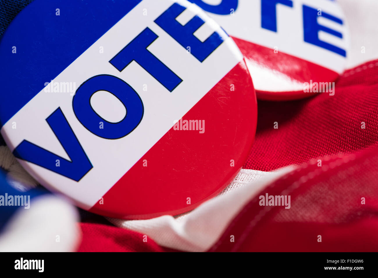 A "VOTE" pin or button on a flag of the United States Stock Photo - Alamy