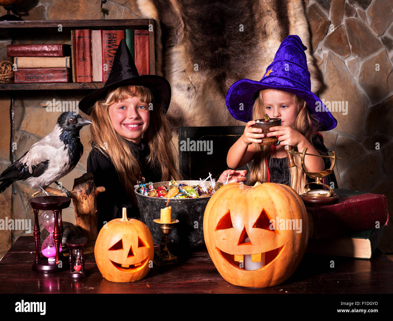 Witch children with pumpkin lantern Stock Photo - Alamy