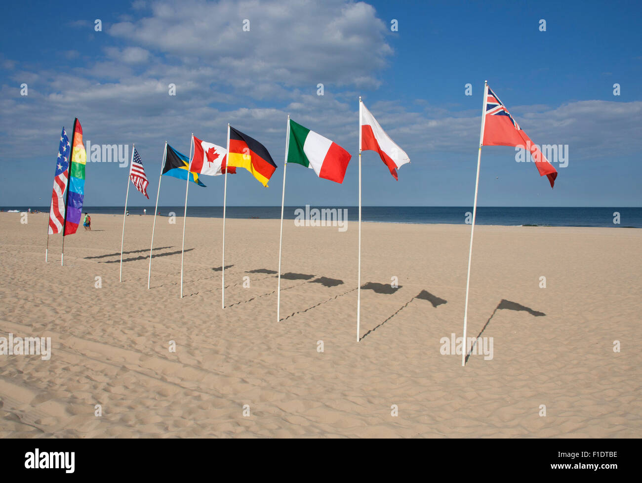 Ocean City, MD – May 13, 2015: A row of flags stand in the sand in ...