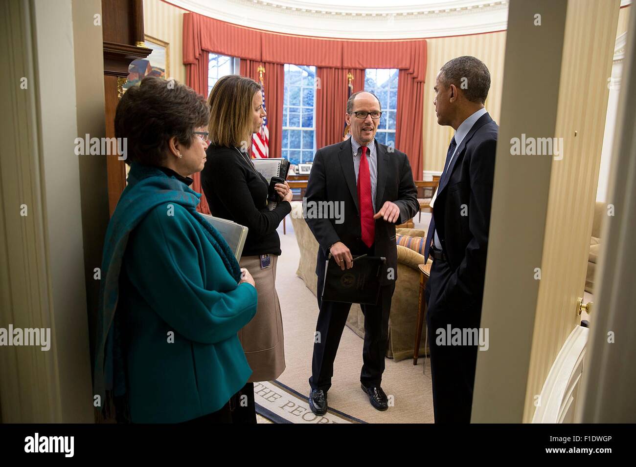 U.S. President Barack Obama speaks with Labor Secretary Thomas Perez ...
