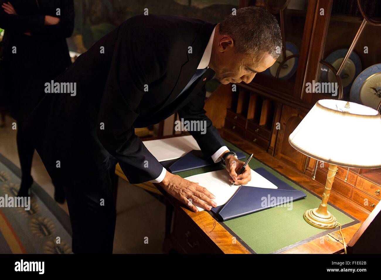 U.S. President Barack Obama signs two copies of the State of the Union ...