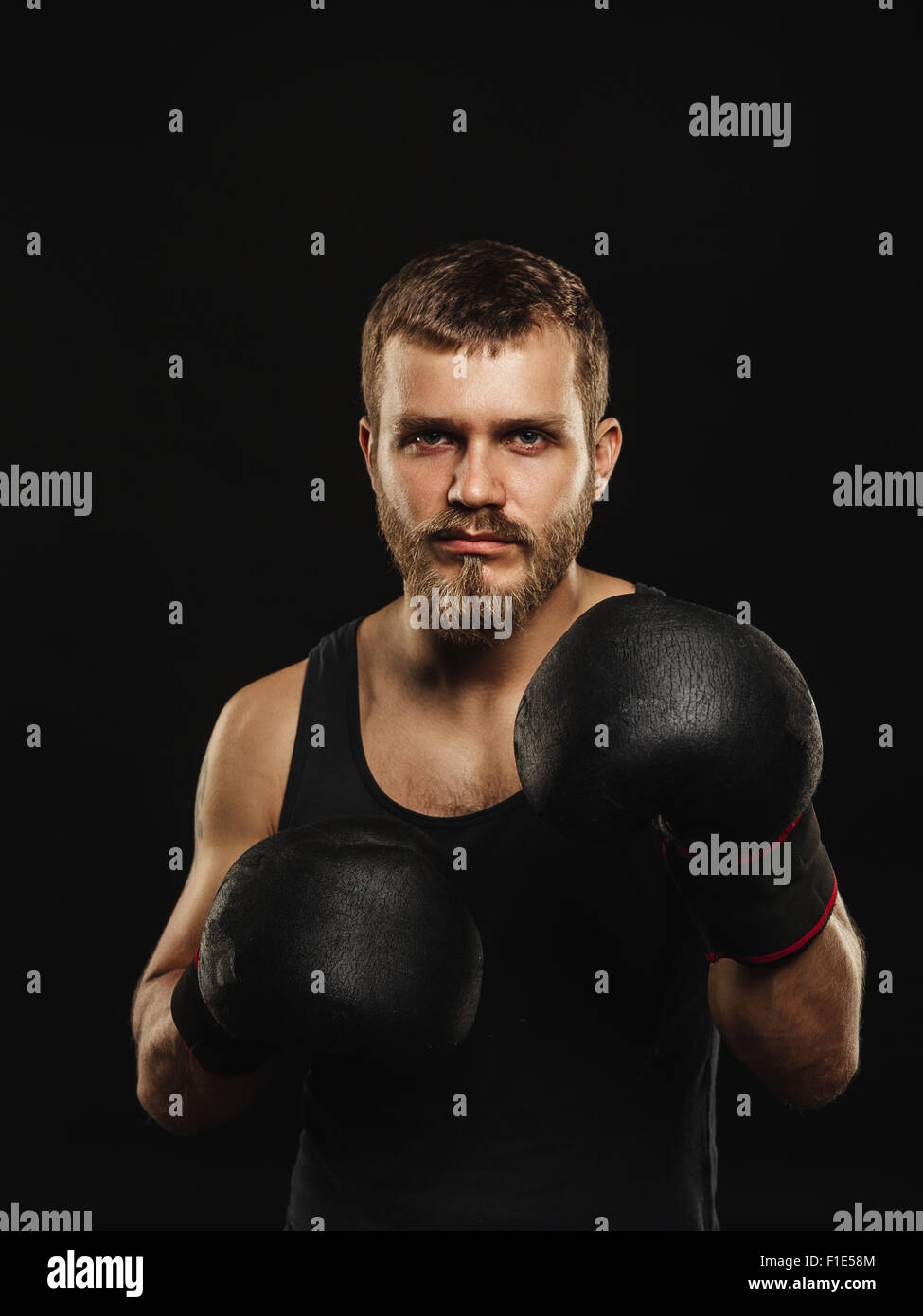 Athletic bearded boxer with gloves on a dark background Stock Photo - Alamy
