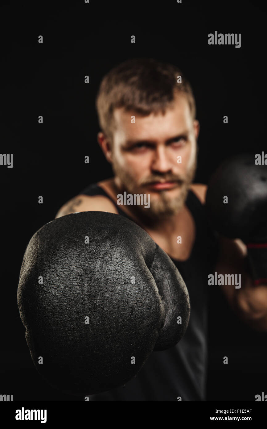 Athletic bearded boxer with gloves on a dark background Stock Photo - Alamy