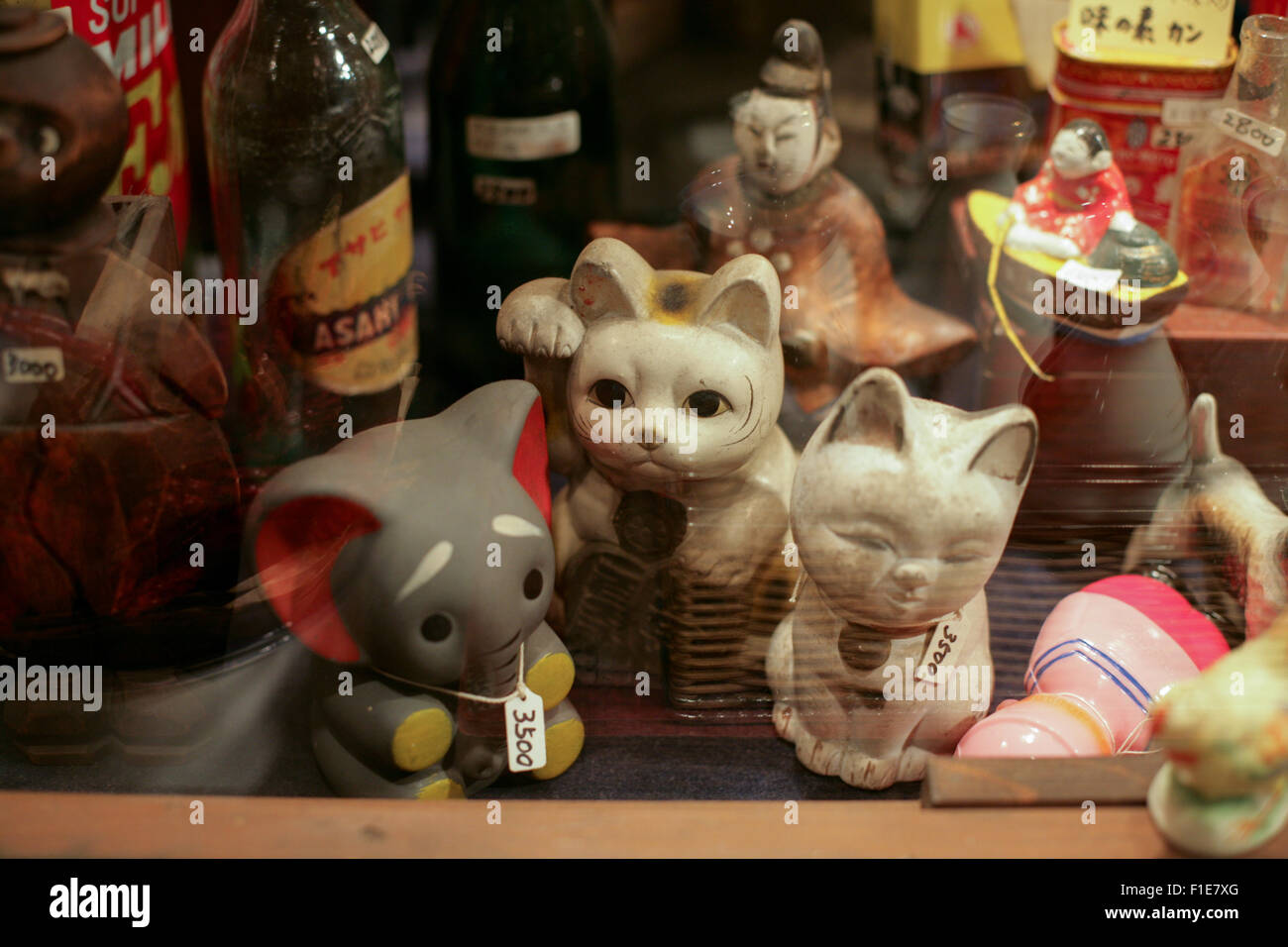 Window display of old Japanese antiques lucky cat elephant close Stock ...