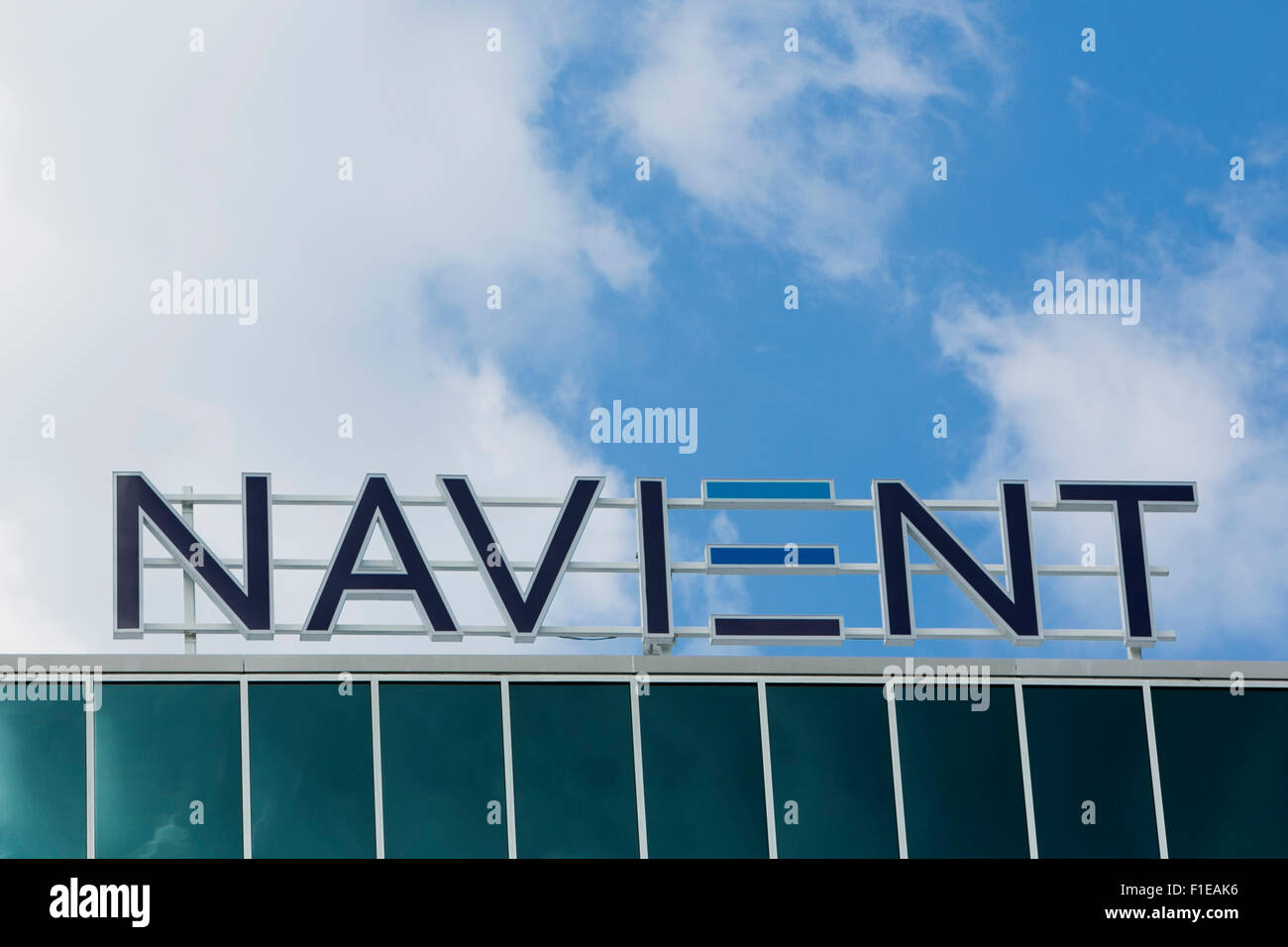 A logo sign outside of the headquarters of the Navient Corporation in ...