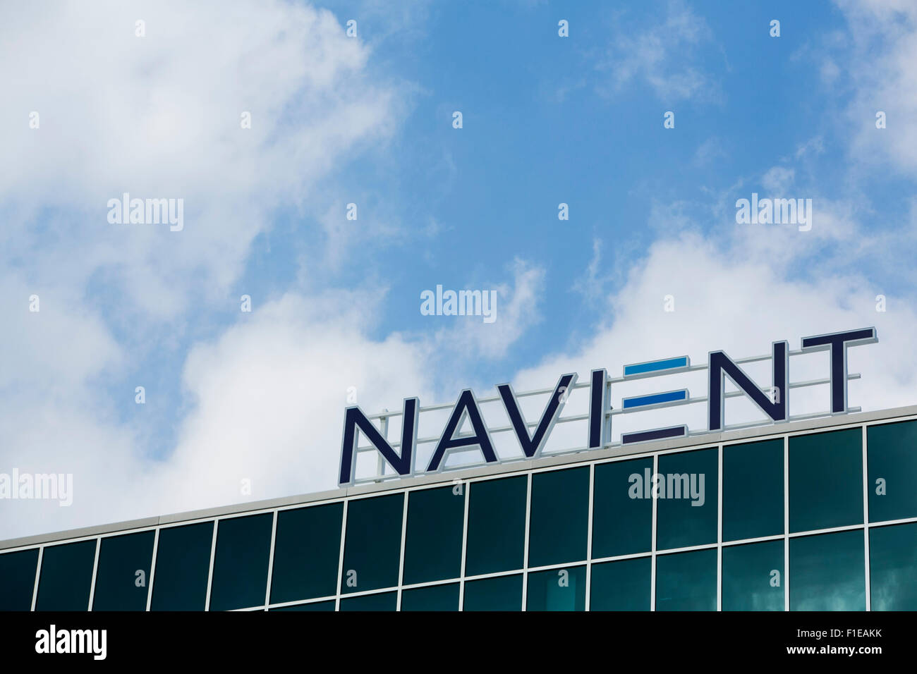A logo sign outside of the headquarters of the Navient Corporation in ...