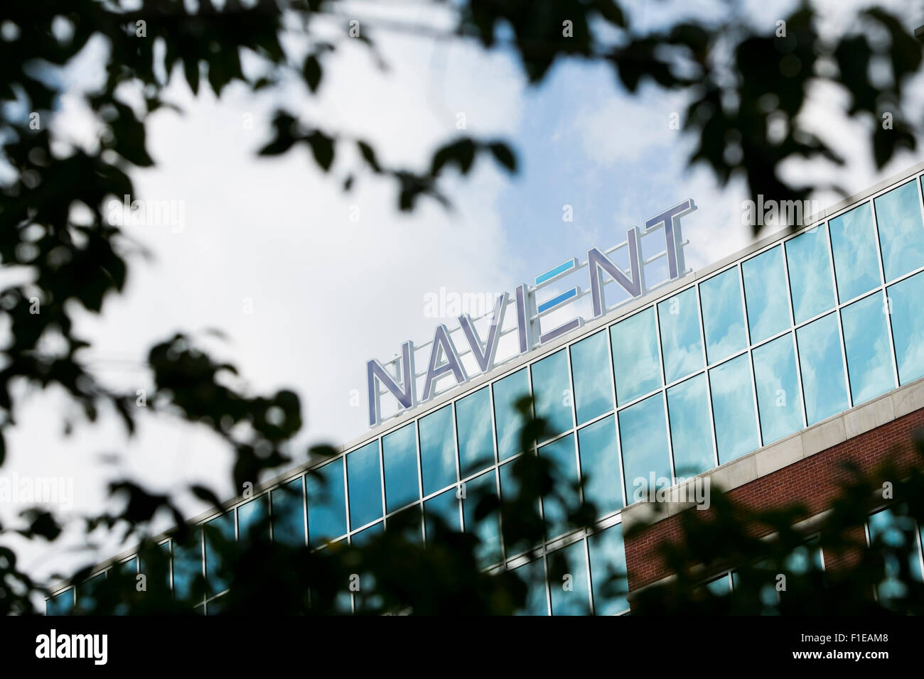 A logo sign outside of the headquarters of the Navient Corporation in ...