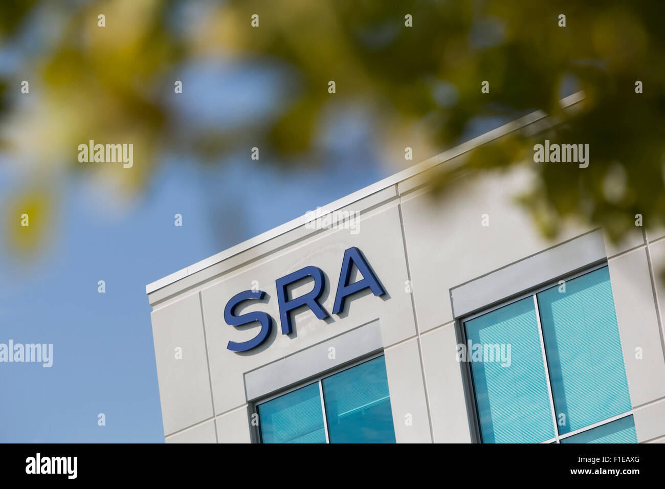 A logo sign outside of a facility occupied by SRA International, Inc ...