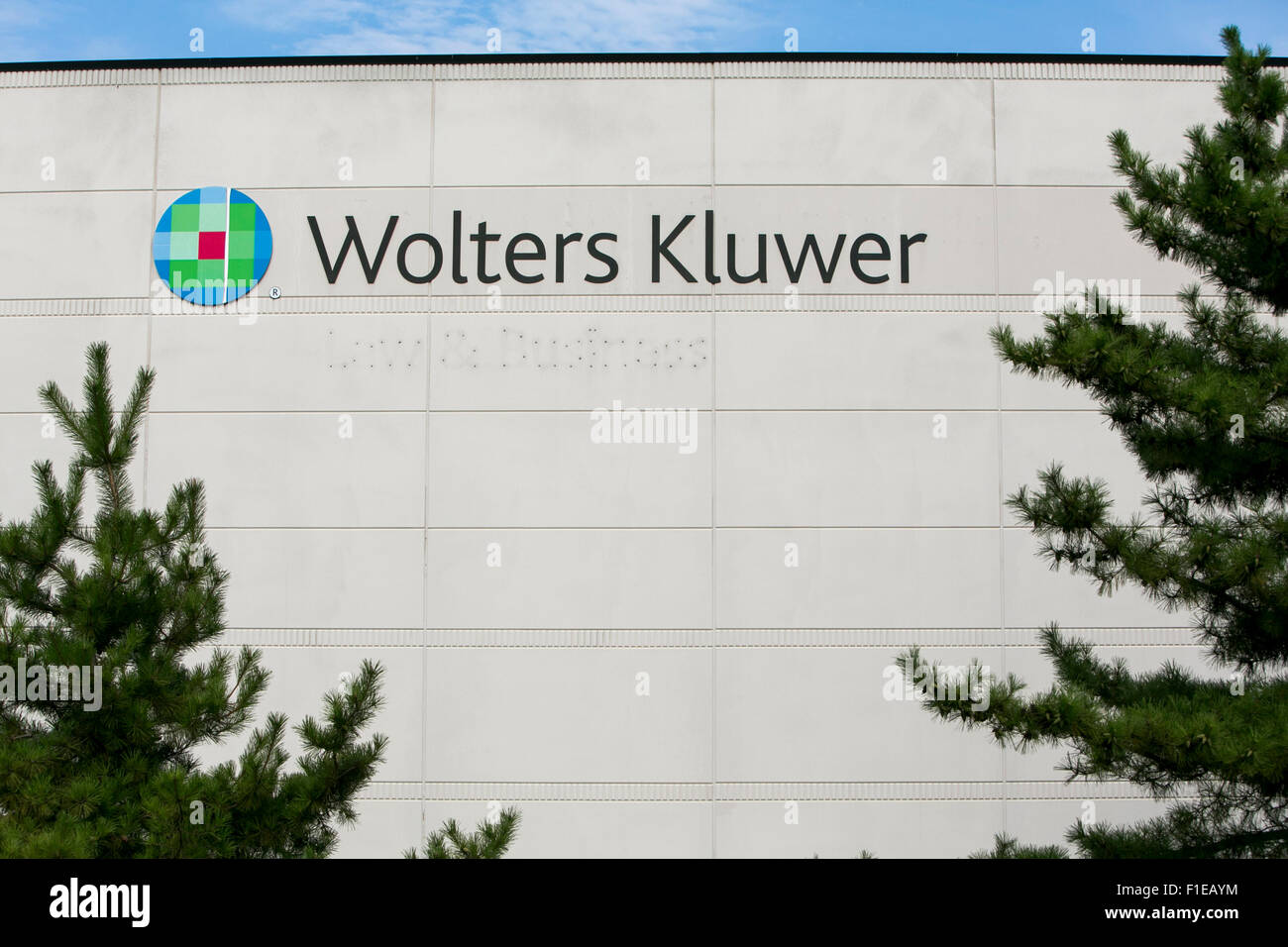 A logo sign outside of a facility occupied by Wolters Kluwer in ...