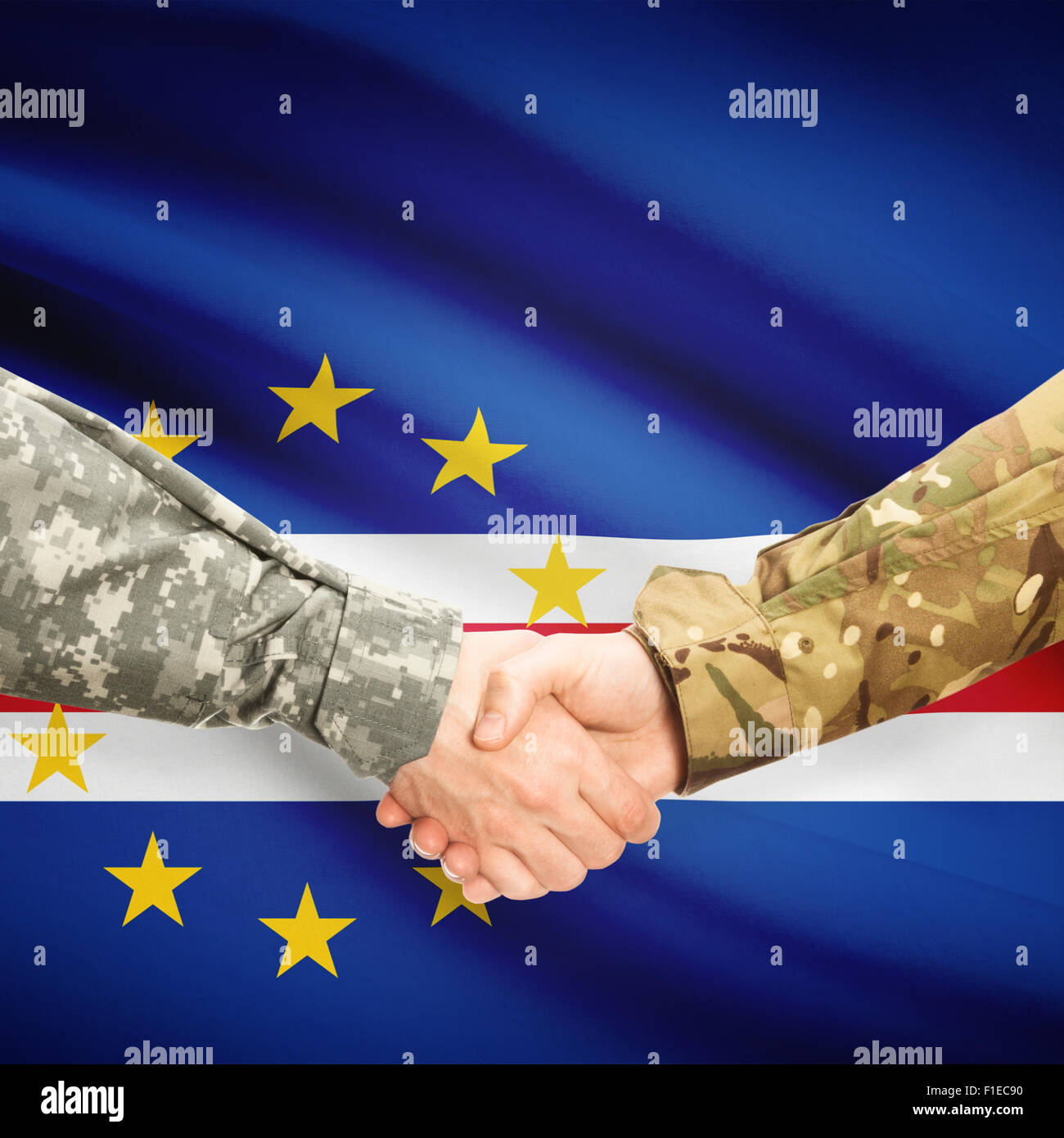 Soldiers shaking hands with flag on background - Cape Verde Stock Photo ...