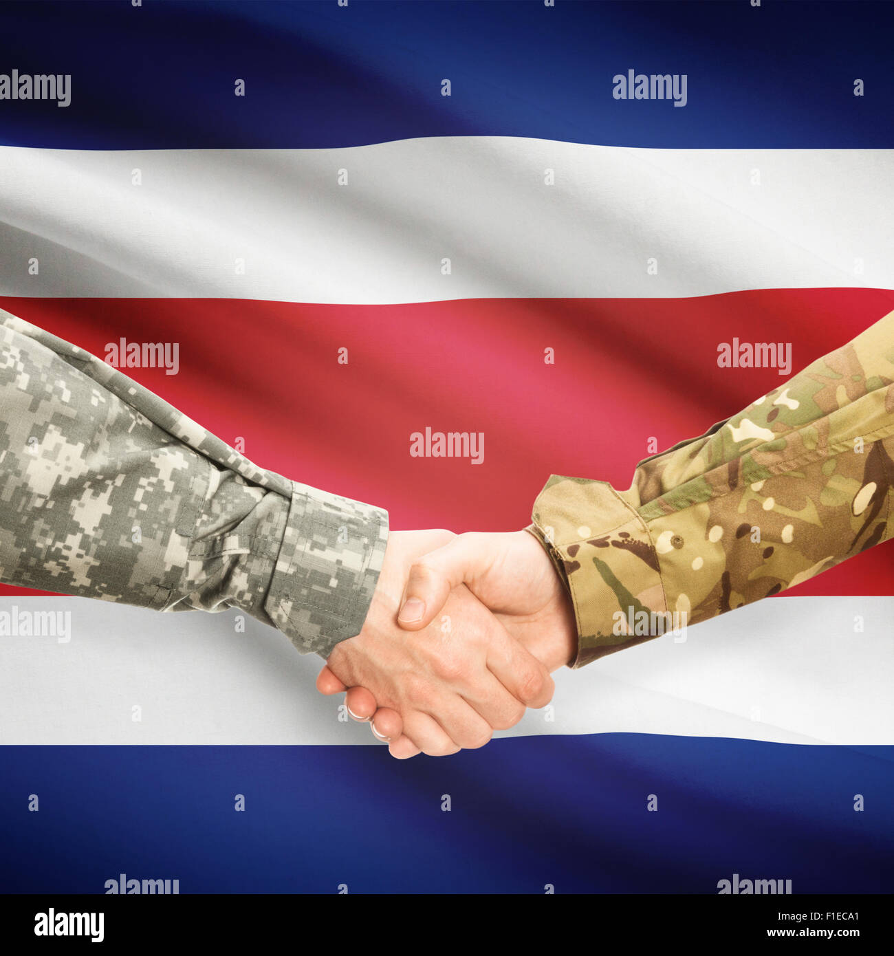 Soldiers shaking hands with flag on background - Costa Rica Stock Photo ...
