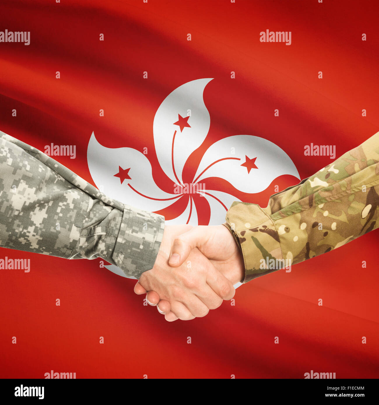 Soldiers shaking hands with flag on background - Hong Kong Stock Photo ...