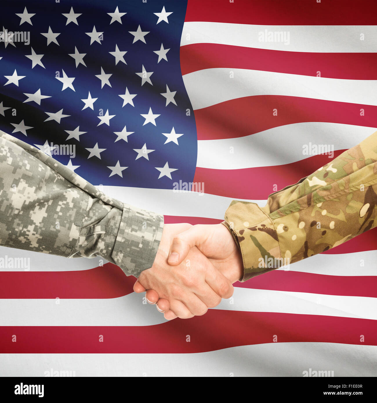 Soldiers shaking hands with flag on background - United States Stock ...