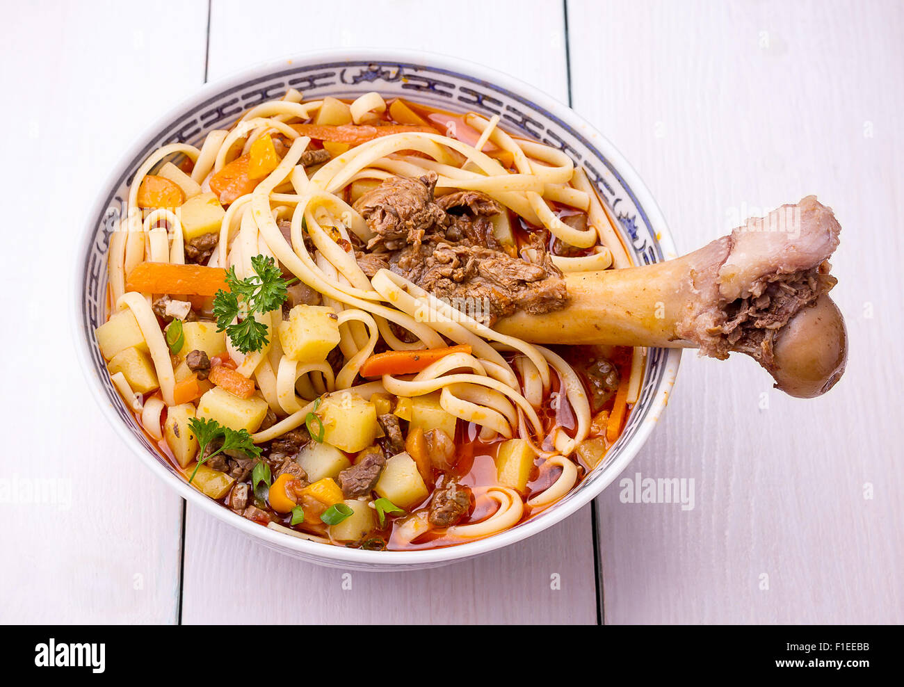 Uzbek noodle soup Lagman with large bone, top view Stock Photo - Alamy