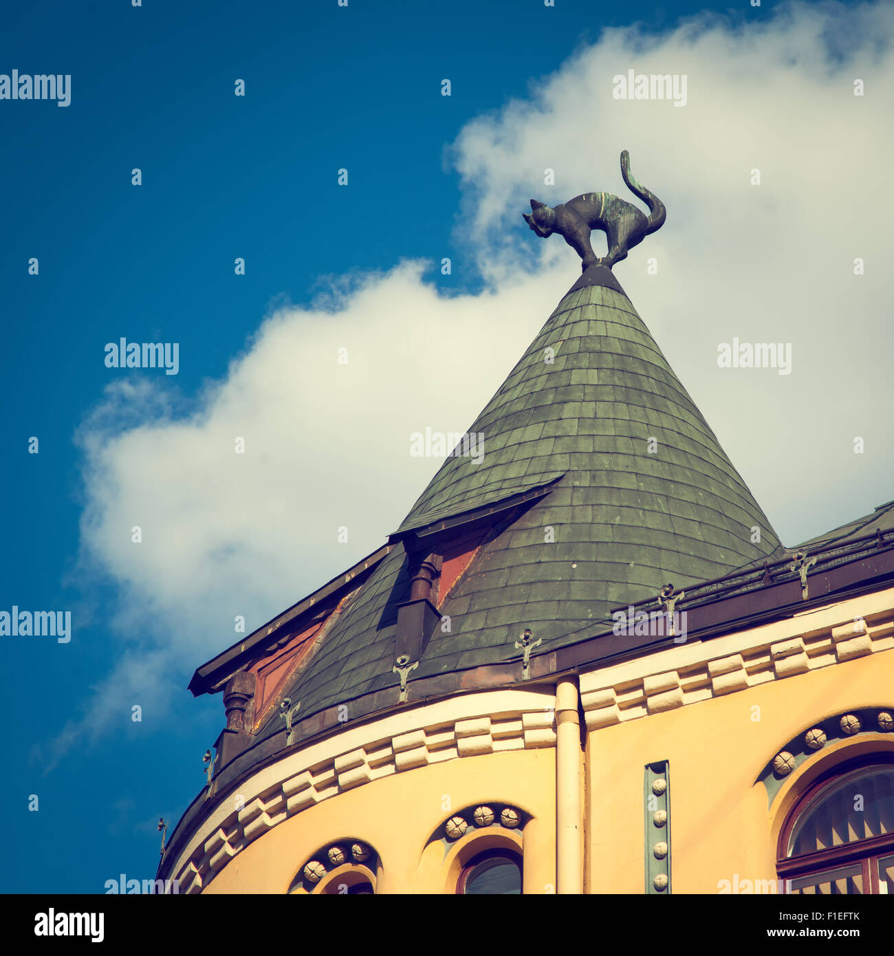 Vintage toned photo of cat sculpture on the roof of Cat House in Riga ...