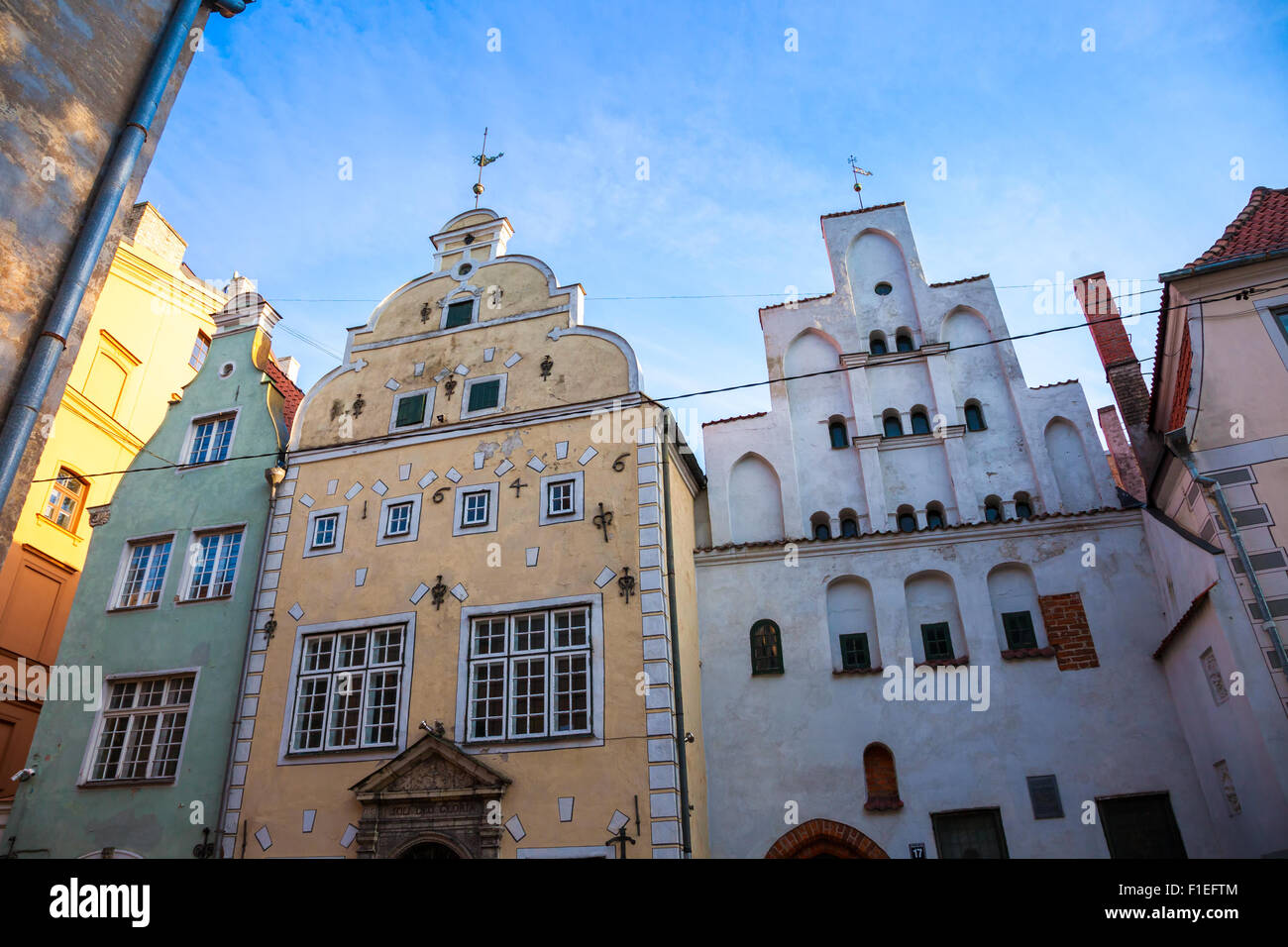 Medieval street in the old Riga city, Latvia. Old buildings - three ...