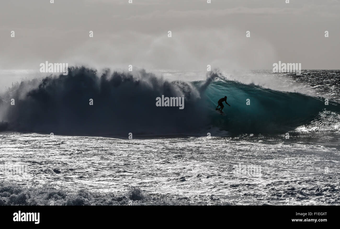 A Surfer's Silhouette on a Back-lit Wave Stock Photo - Alamy