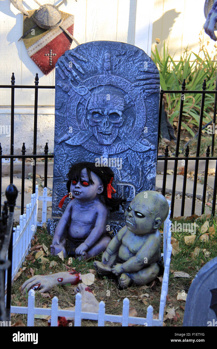 Creepy zombie babies in front of gravestone Stock Photo - Alamy