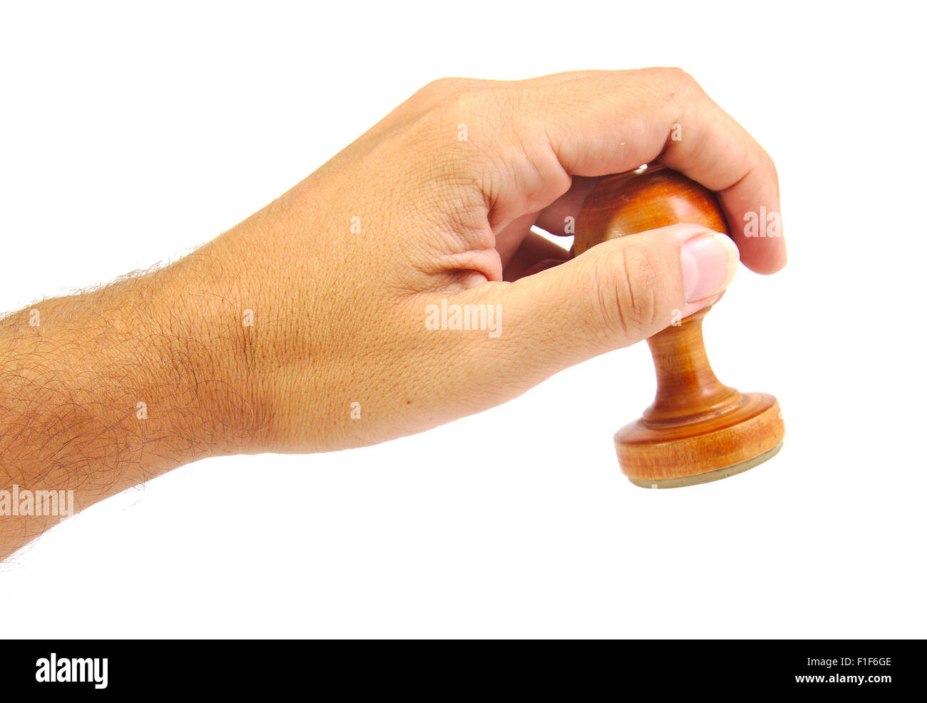 Hand stamping with an old and vintage wooden stamper isolated on white ...