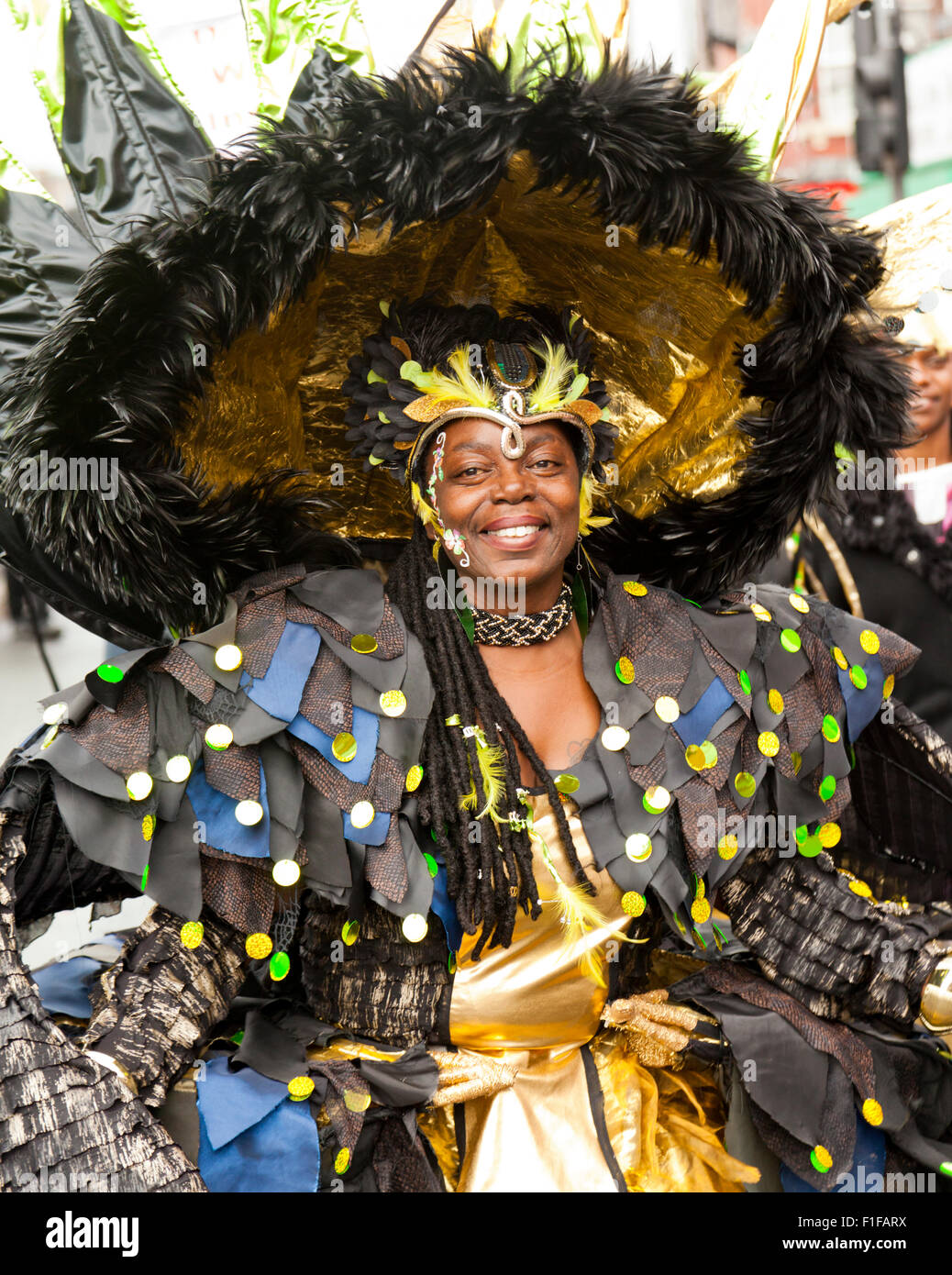 Leeds, UK. 31st Aug, 2015. A woman dressed in carnival costume dances ...