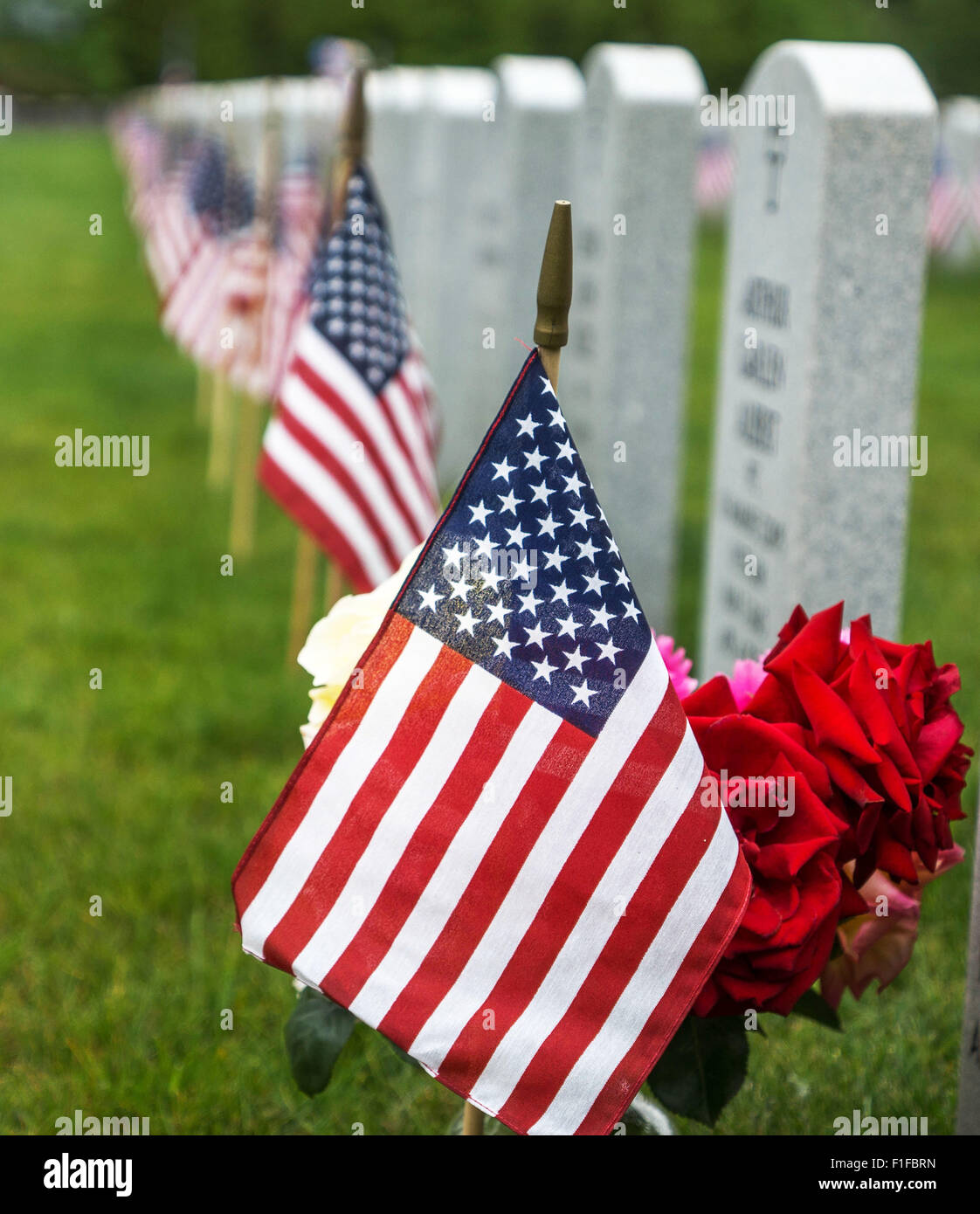 American flag and tombstones at an American National Cemetery Stock ...