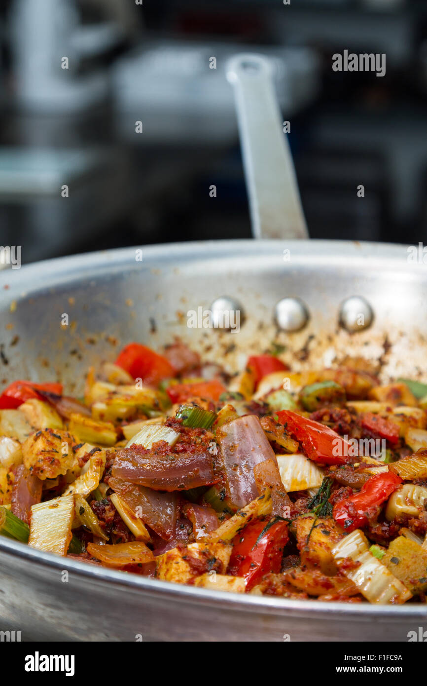 close up of fresh cooked vegetables in a pan with seasonings and spices ...