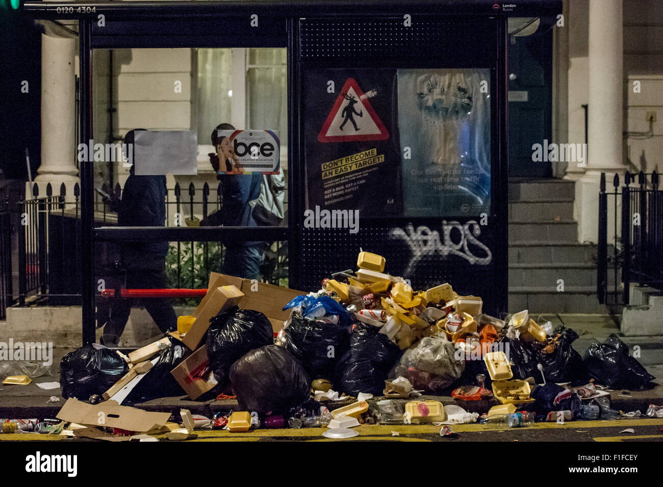 London, UK. 31 August, 2015. A pile of litter by a bus stop near ...