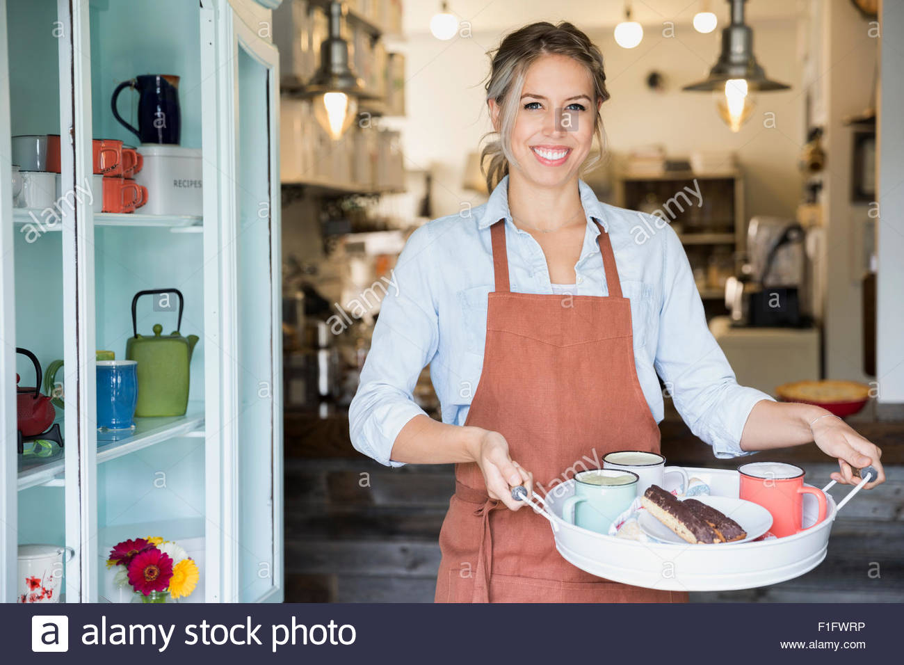 Young woman carrying tray hi-res stock photography and images - Alamy