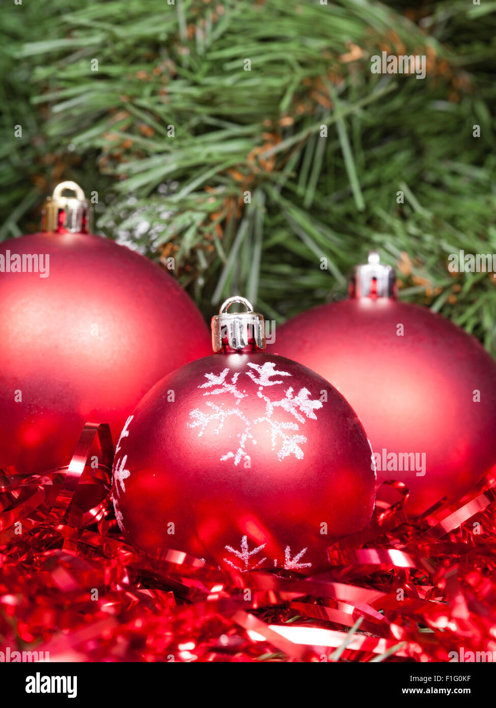 vertical Christmas still life - red Christmas balls, tinsel close up on ...