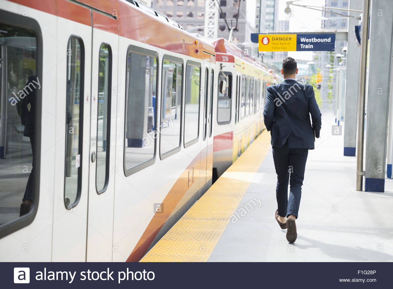 Businessman running for train at station hi-res stock photography and ...