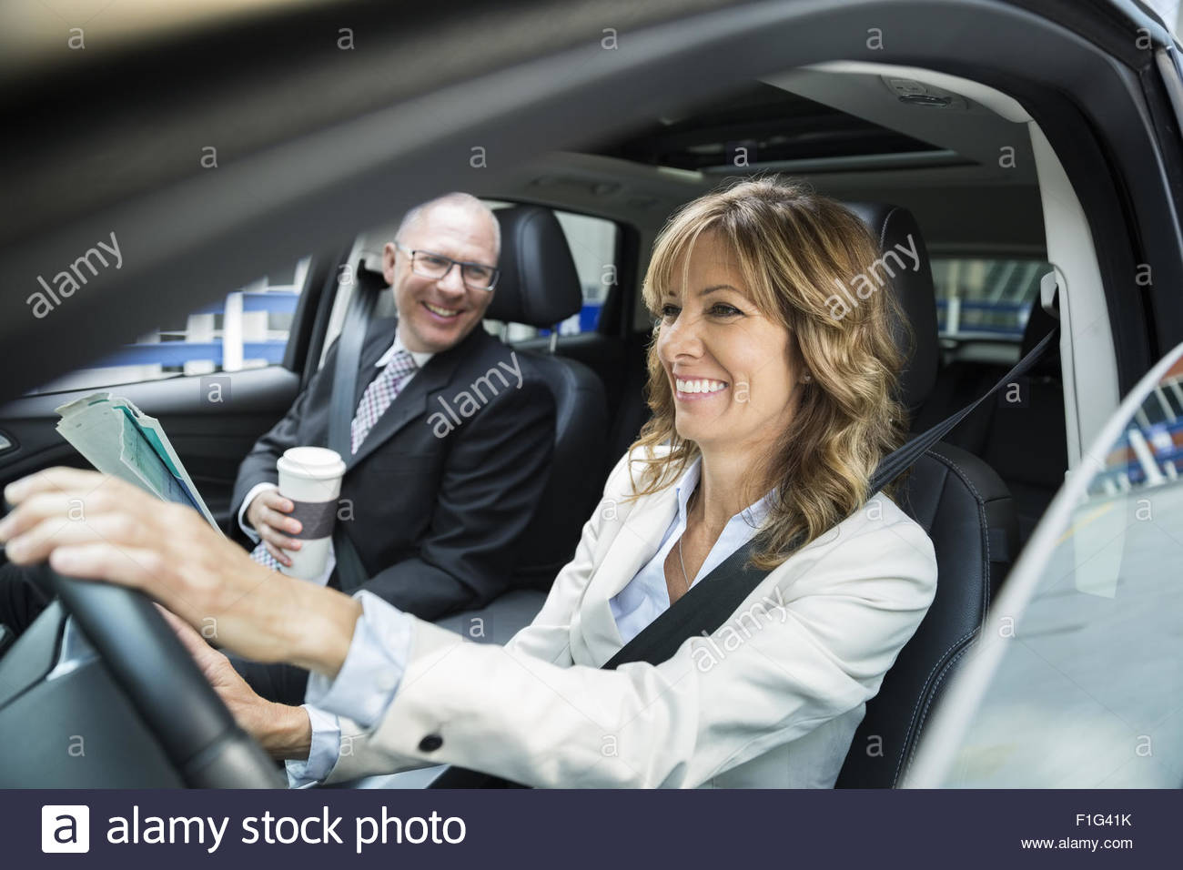 Smiling business people carpooling in car Stock Photo - Alamy