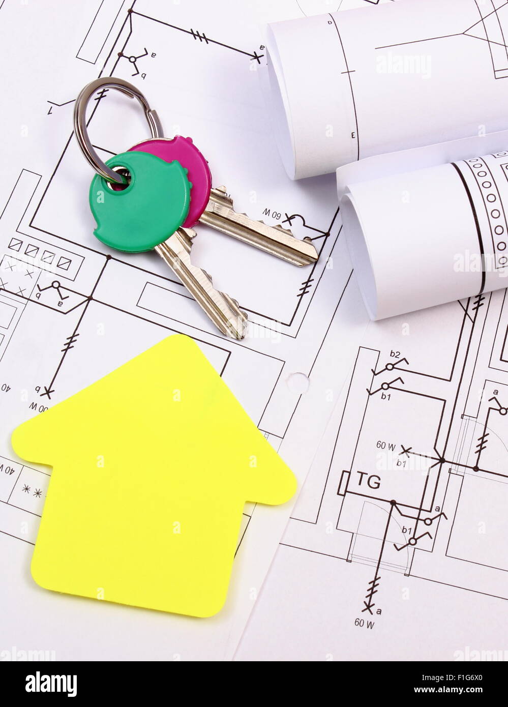House of yellow paper, home keys and rolls of diagrams lying on ...