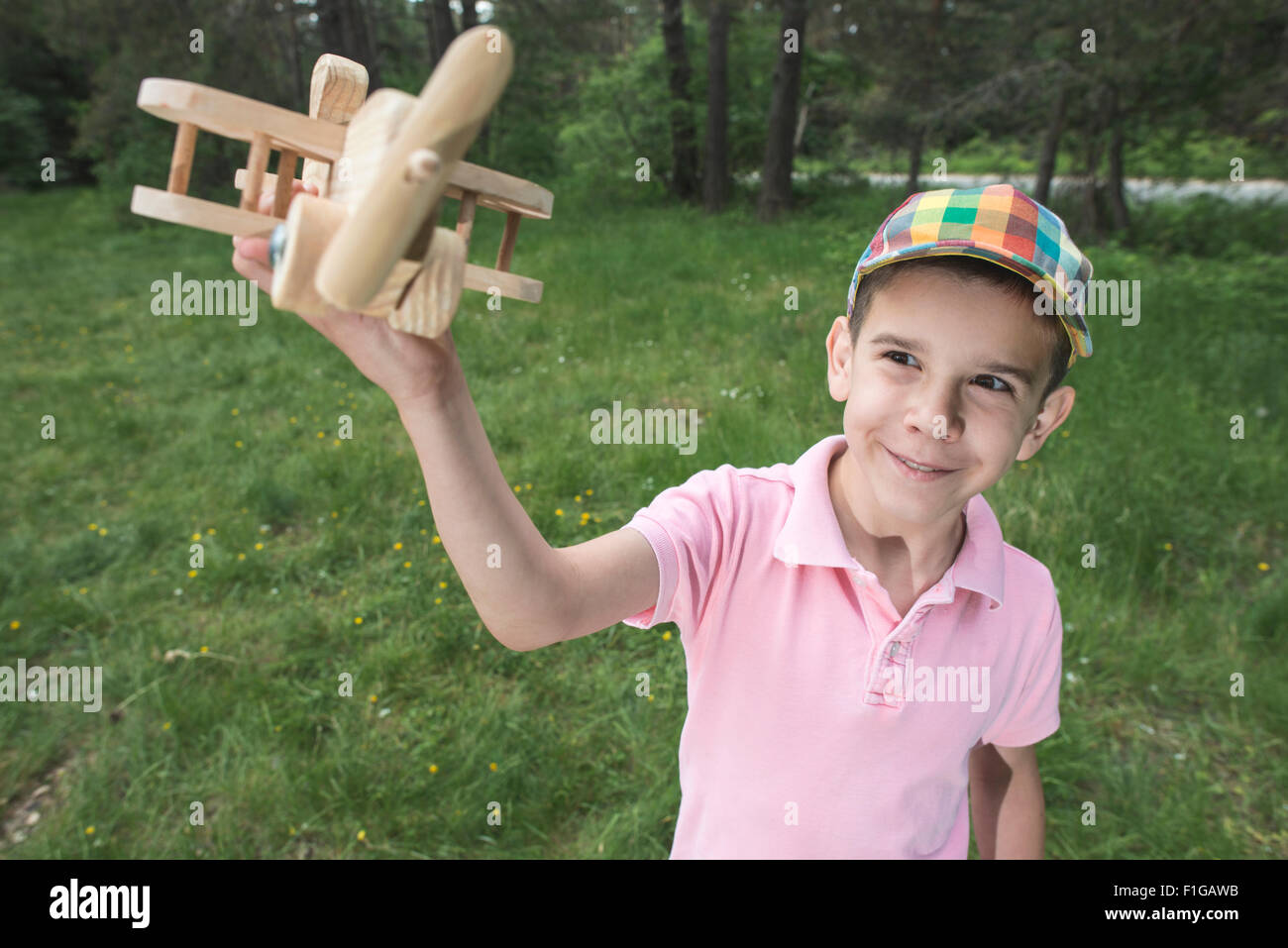 Child play with a wooden plane in the mountain. Forest Stock Photo - Alamy
