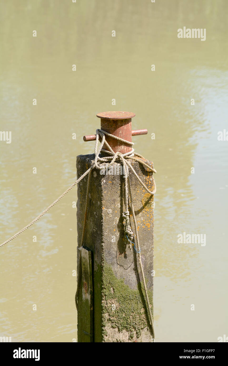Boat mooring post on river with lots of ropes attached to stop boats ...