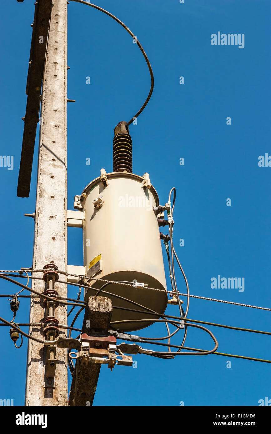 High voltage electricity pot with blue sky background Stock Photo - Alamy