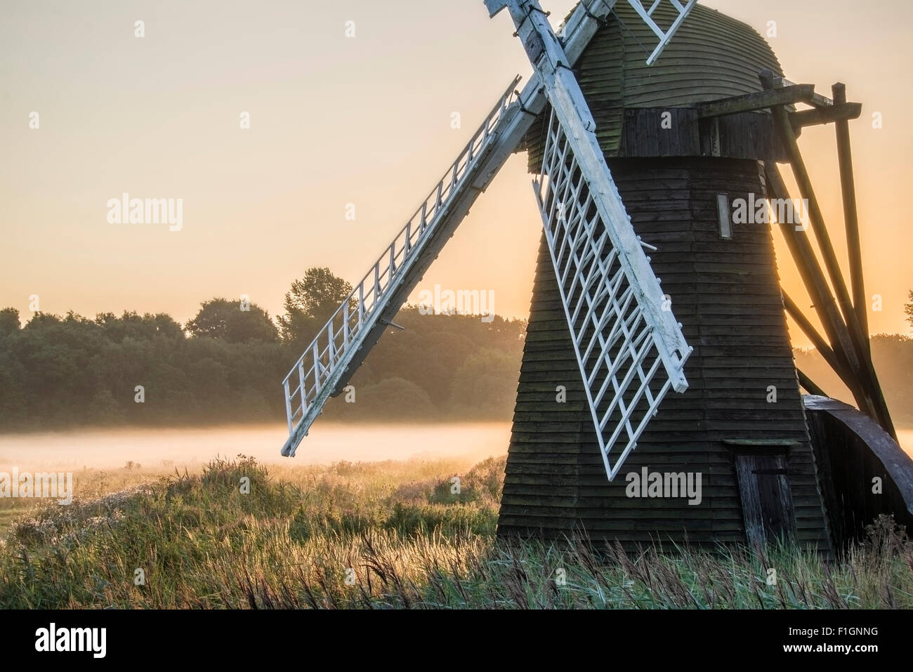 Old windmill in foggy English countryside landscape Stock Photo - Alamy