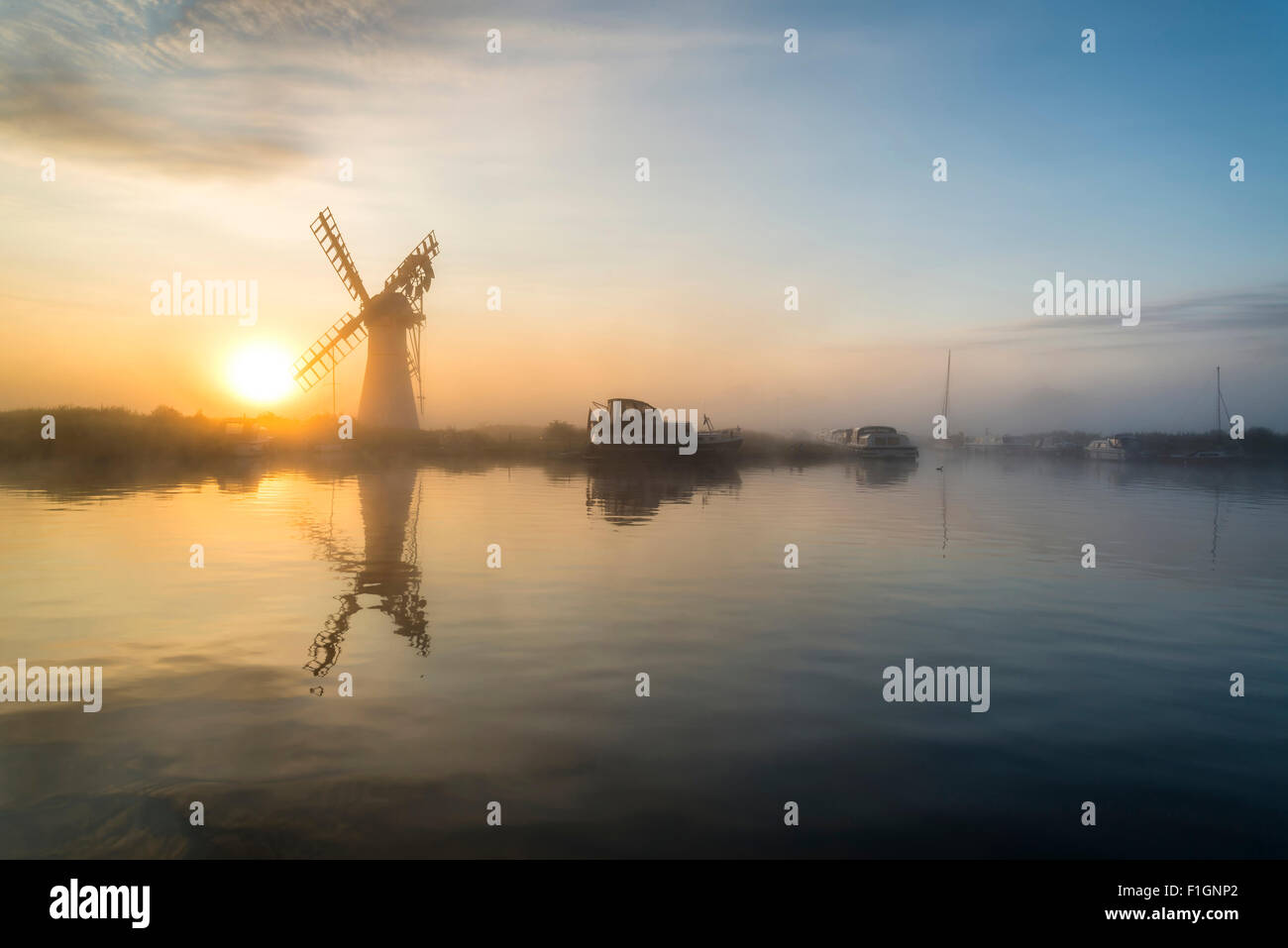 Stunning landscape of windmill and river at sunrise on Summer morning ...