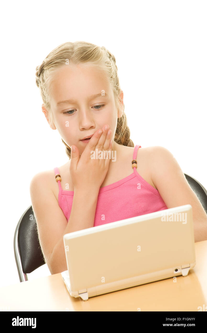 Surprised little girl with laptop Stock Photo - Alamy