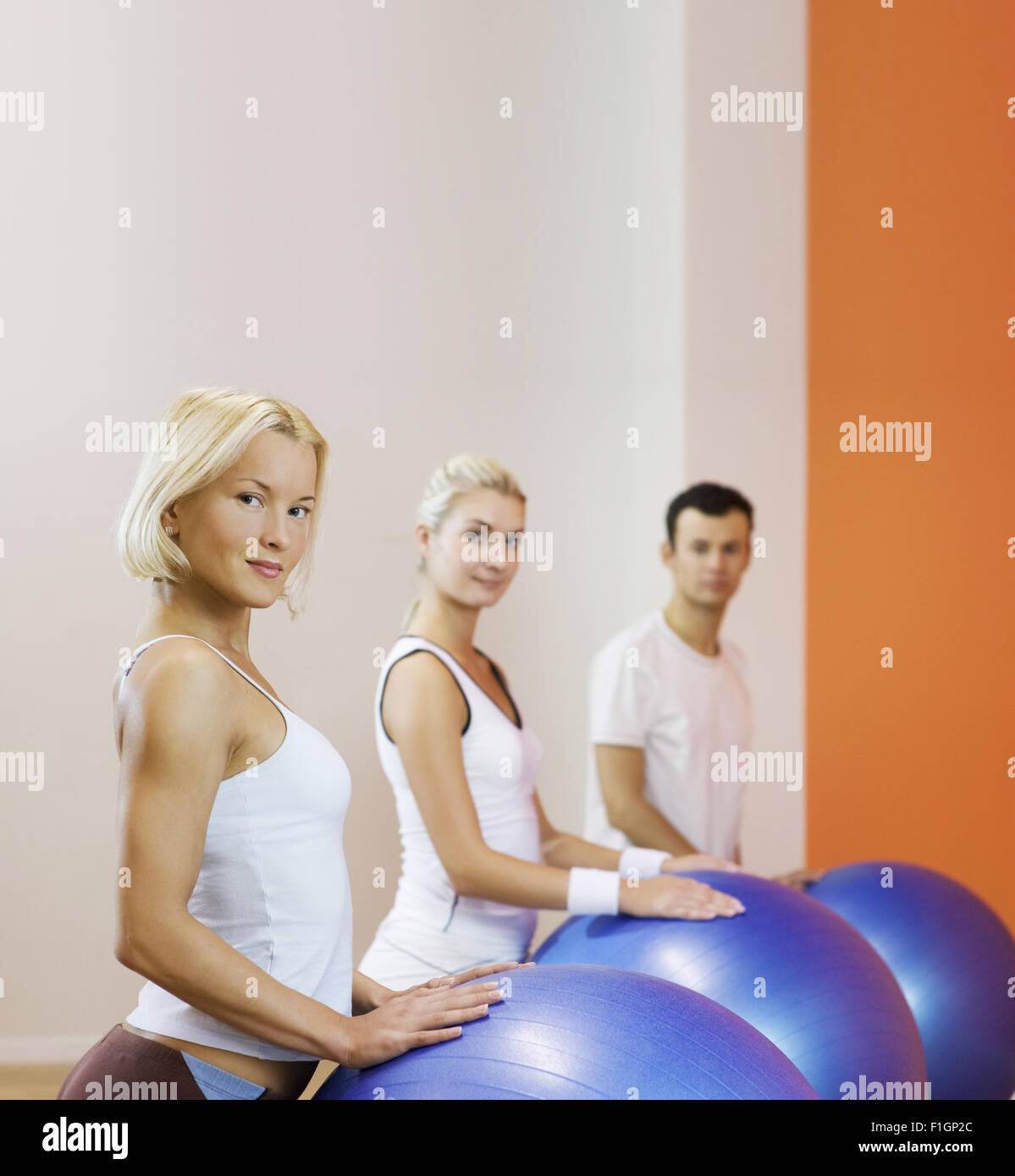 Group of people doing fitness exercise with a ball Stock Photo - Alamy