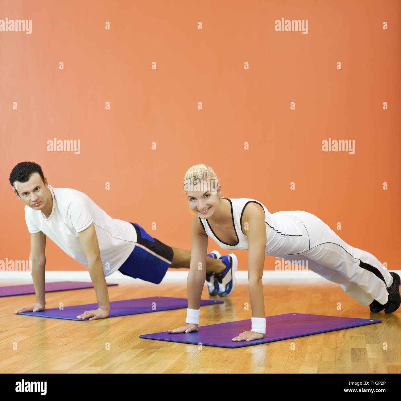 Group of people completing push ups Stock Photo - Alamy