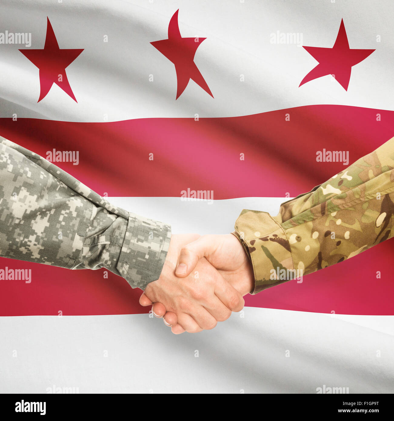 Soldiers handshake and US state flag - District of Columbia Stock Photo ...