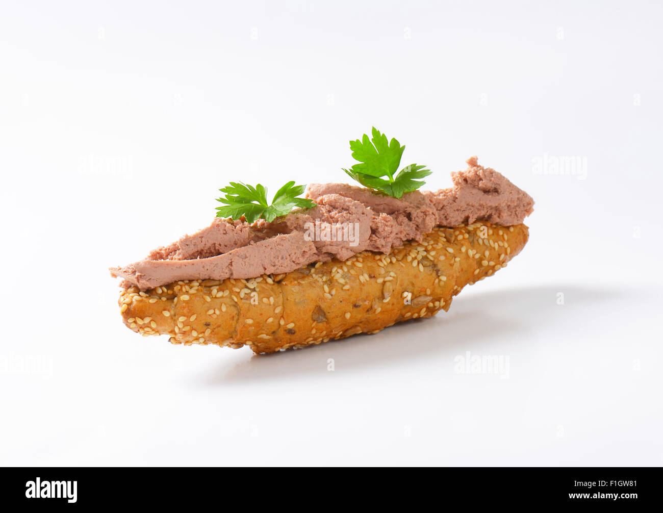 fresh bread roll with pate and parsley on white background Stock Photo ...