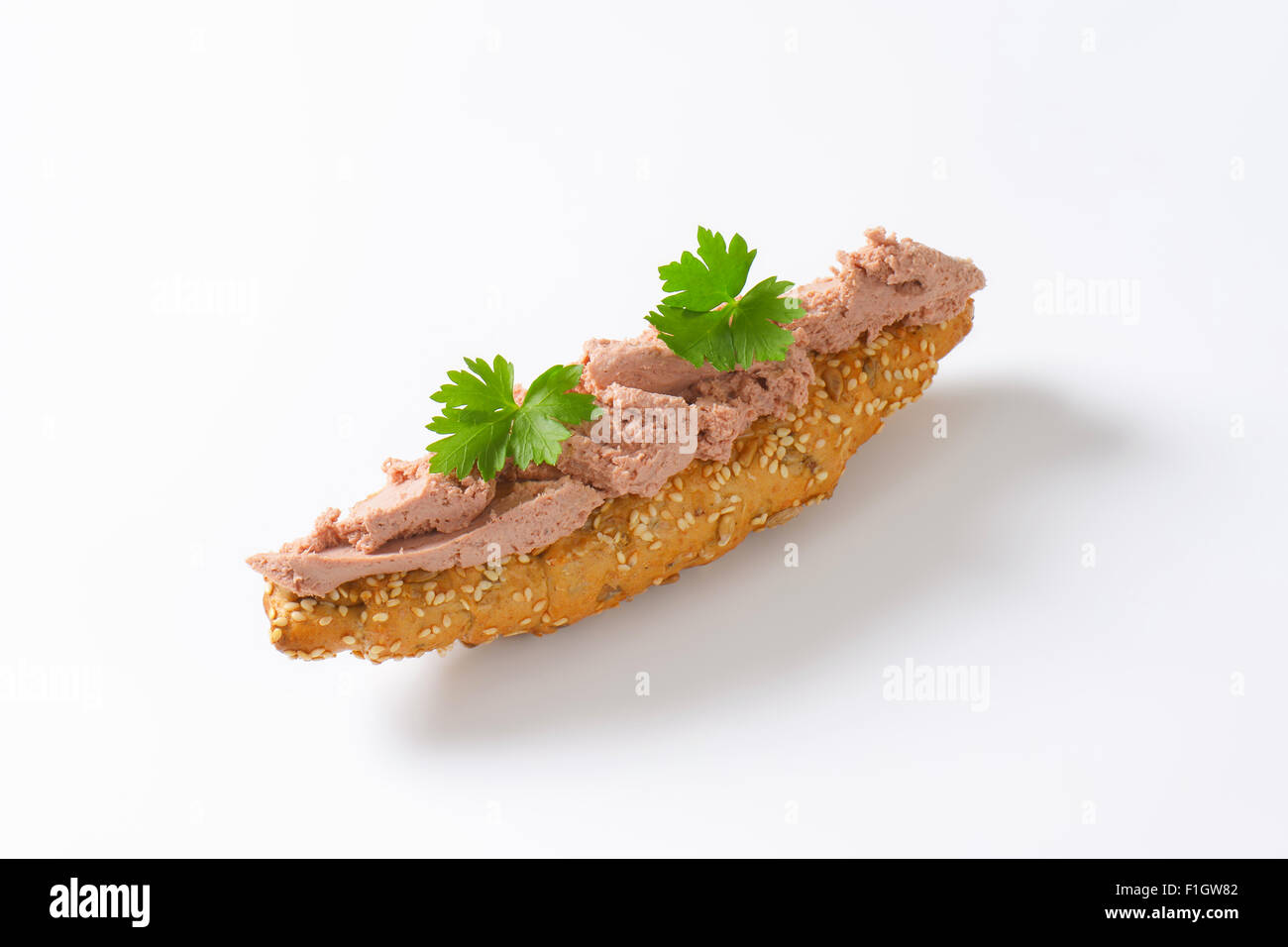 fresh bread roll with pate and parsley on white background Stock Photo ...