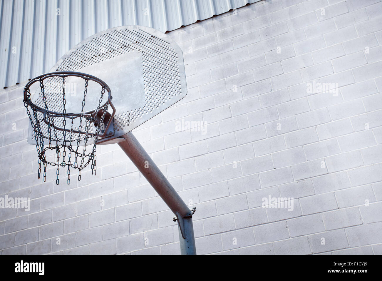 Basketball hoop isolated in urban industrial playground Stock Photo - Alamy