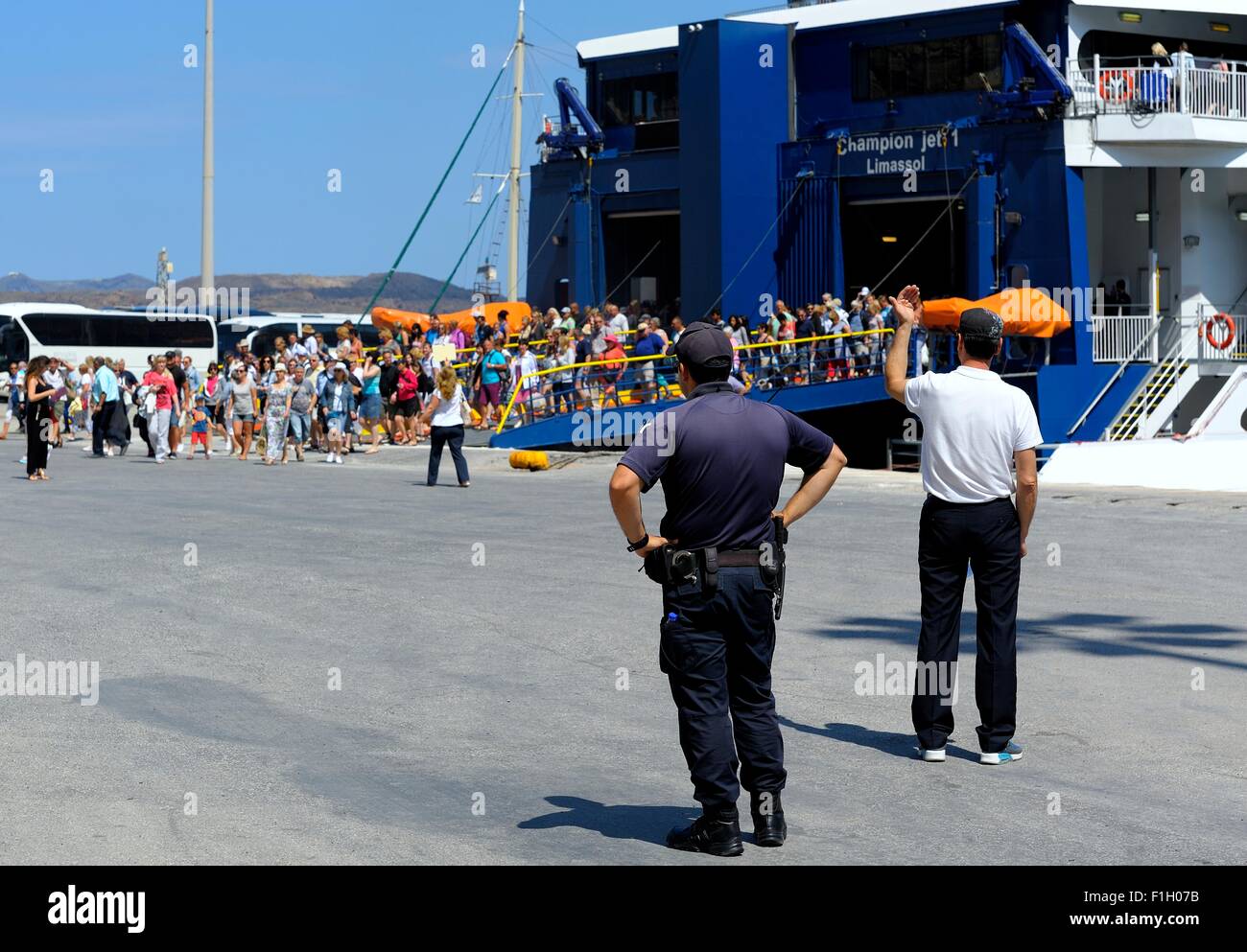 Ferry passengers arriving in the port of Ormos Athinios Santorini ...