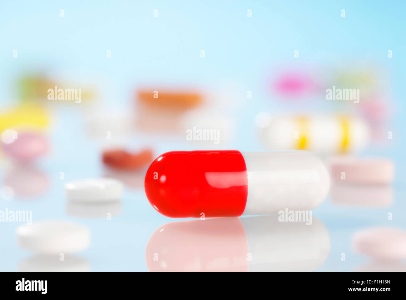 Red coated tablet as closeup Stock Photo - Alamy