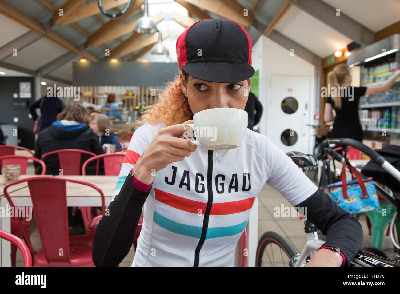 Woman cyclist drinking a hot drink in Velo, a cycle-themed cafe Stock ...