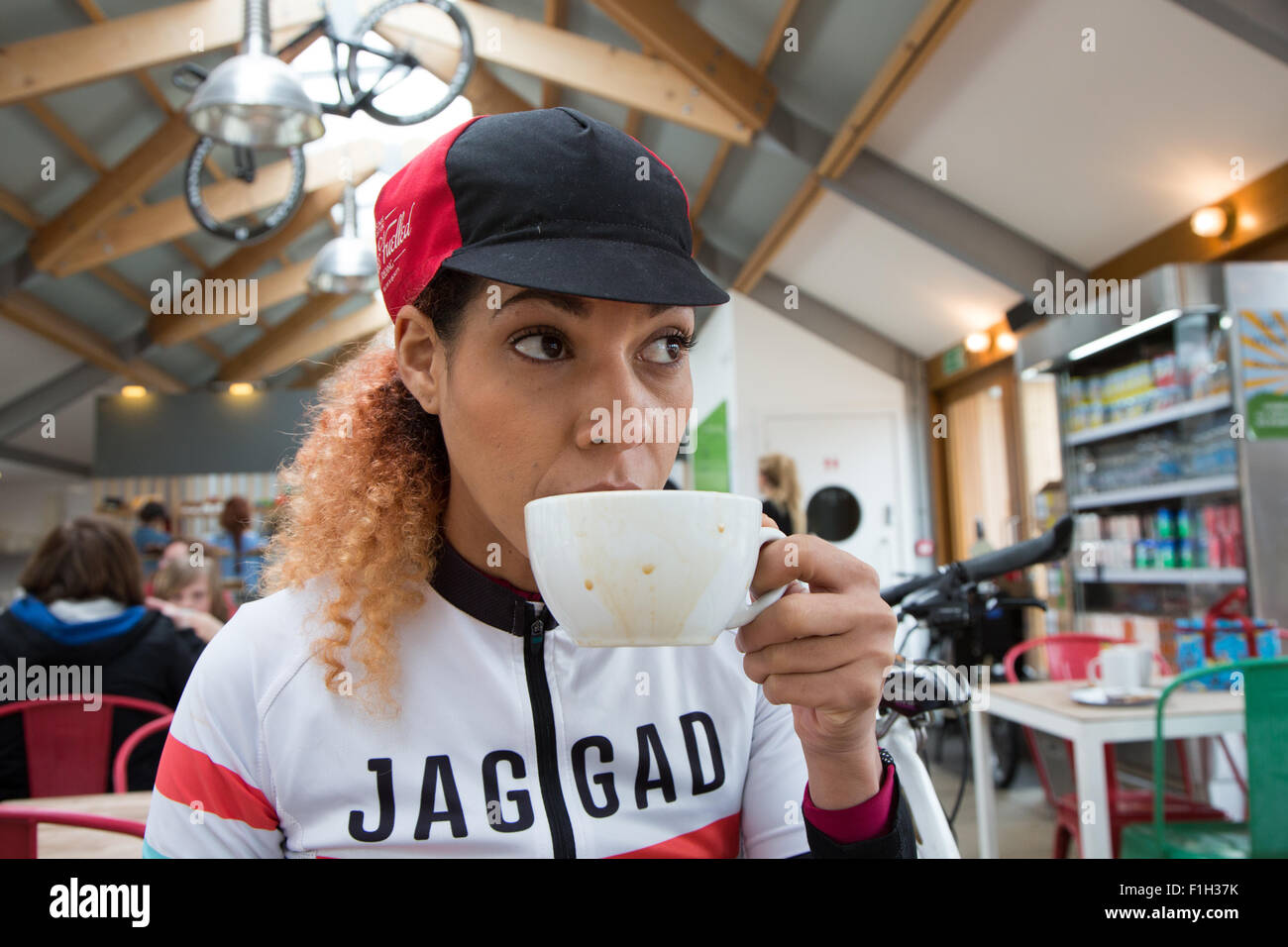 Woman cyclist drinking a hot drink in Velo, a cycle-themed cafe Stock ...