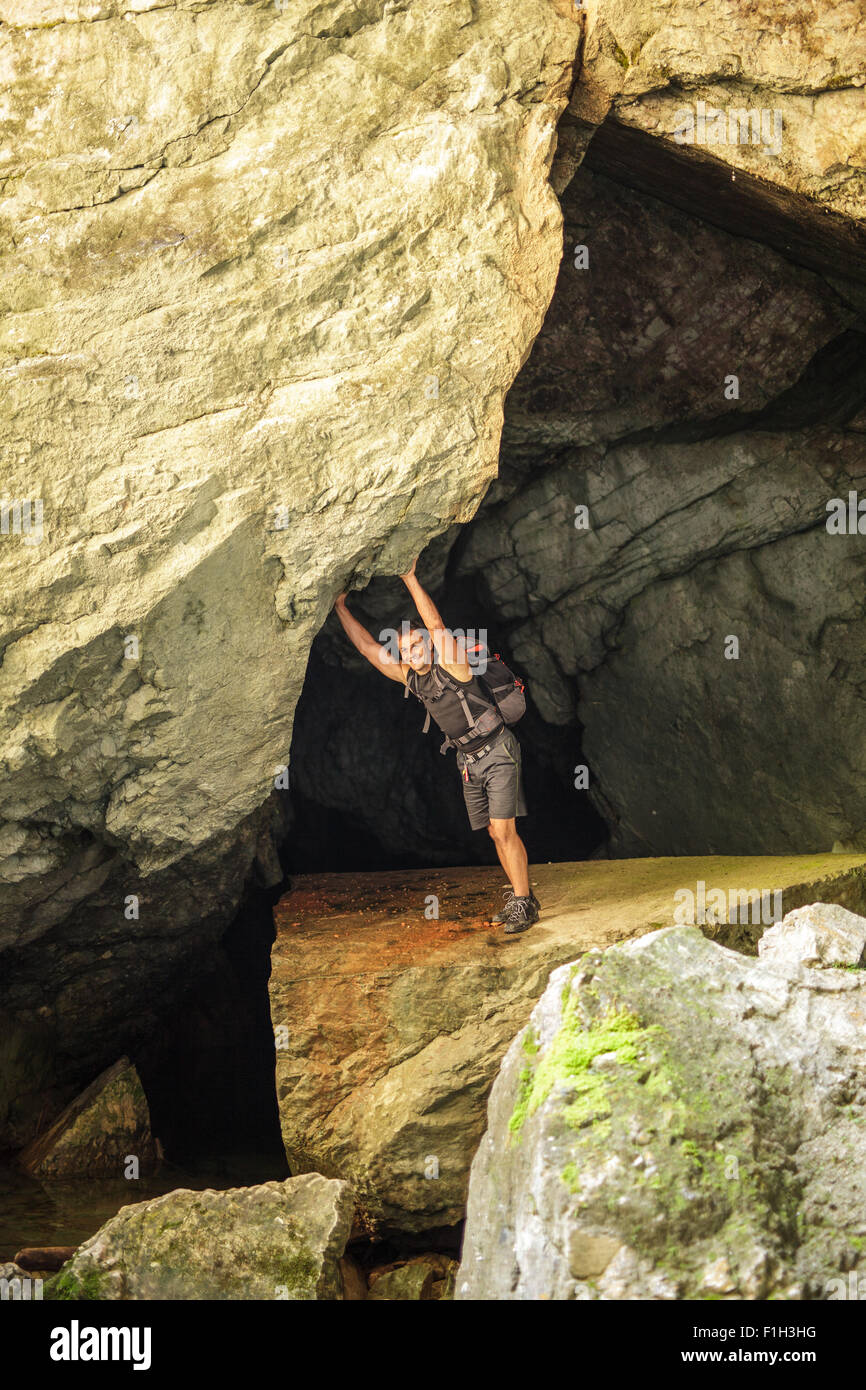 Happy man standing in a large cave Stock Photo - Alamy